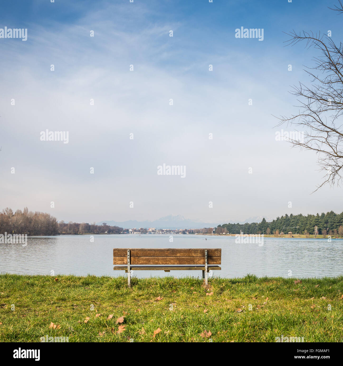 Lonely bench on side of lake Stock Photo - Alamy