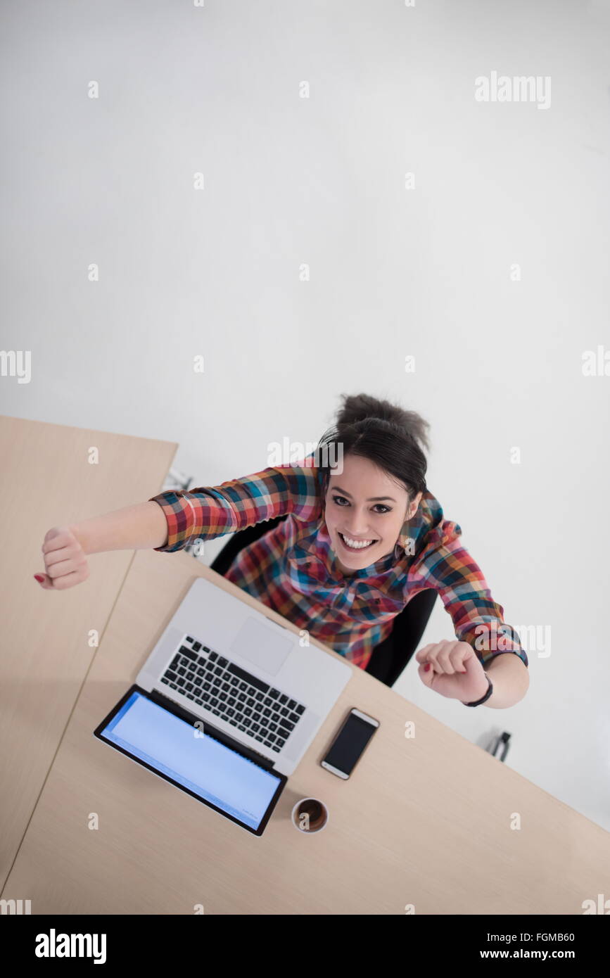 top view of young business woman working on laptop computer in modern ...