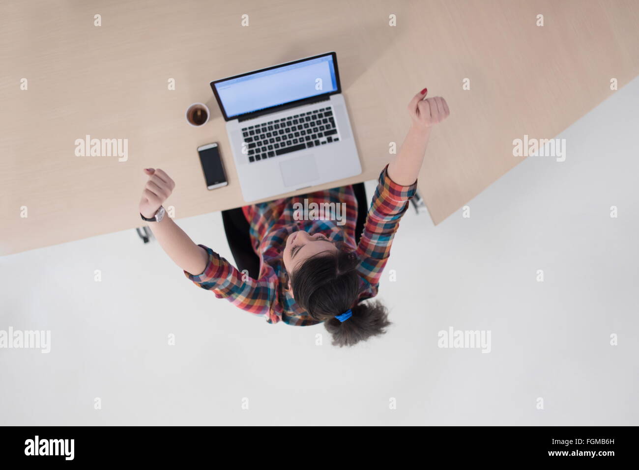 top view of young business woman working on laptop computer in modern ...