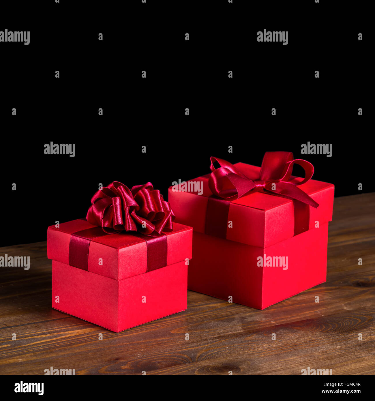 festive boxes with bow on wooden background is isolated, closeup Stock ...