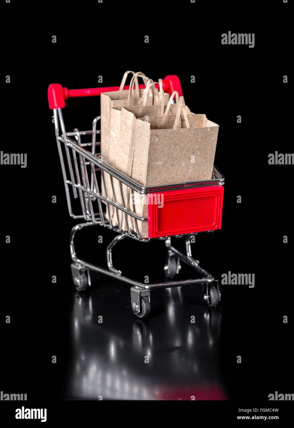 shopping cart with paper bags is isolated on black background Stock ...