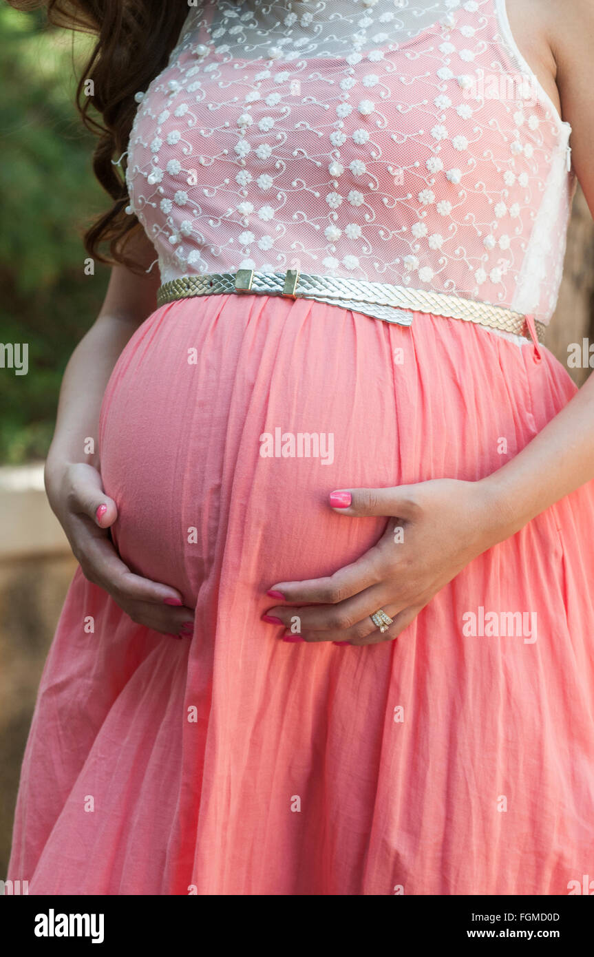 Close up hands belly hi-res stock photography and images - Alamy