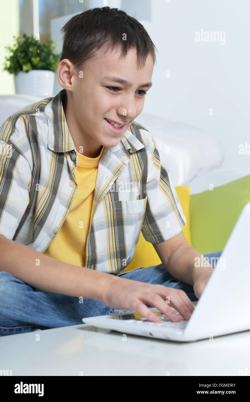 boy with laptop on table Stock Photo - Alamy