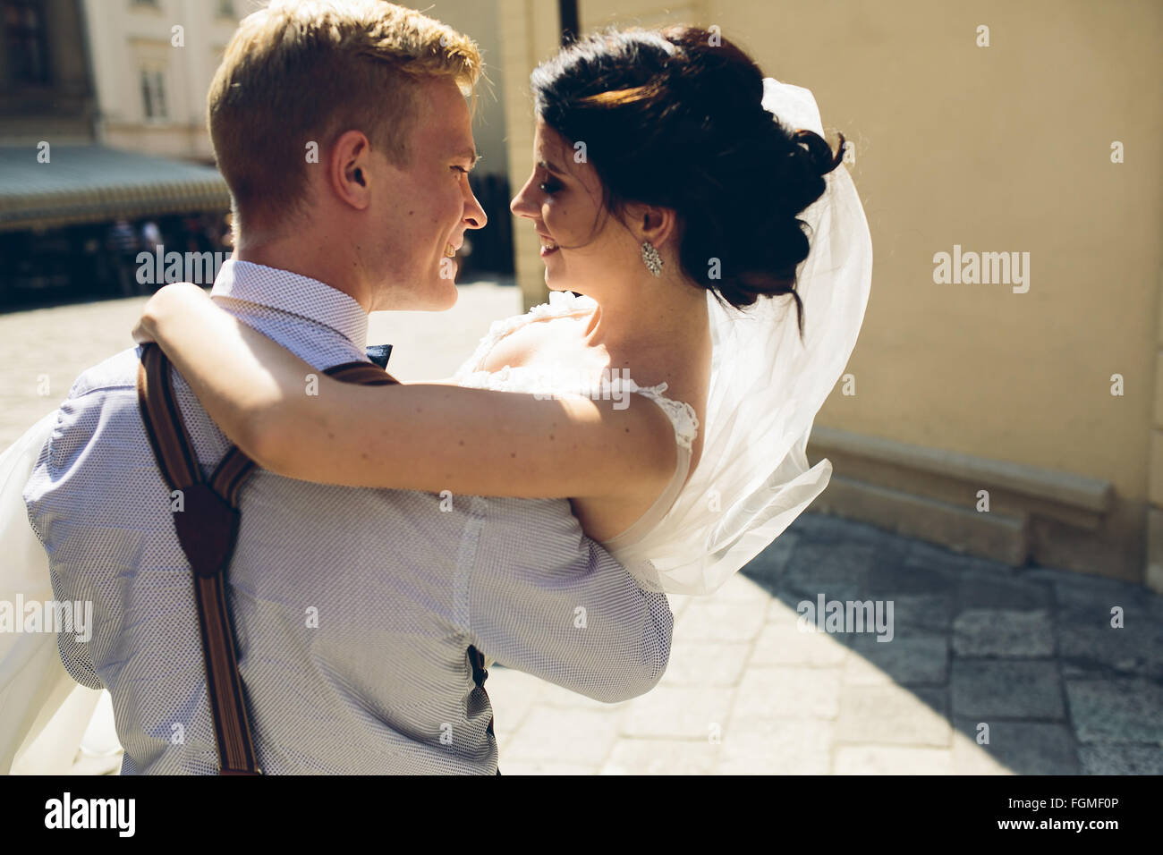 groom carries bride in his arms Stock Photo - Alamy