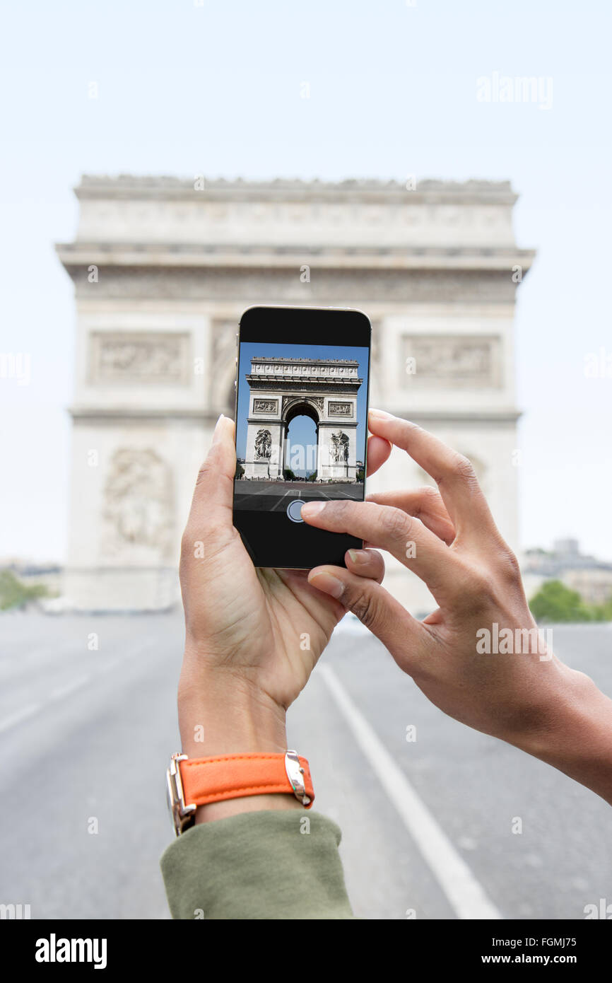 female hand taking photo of Triumphal arch with mobile phone Stock ...