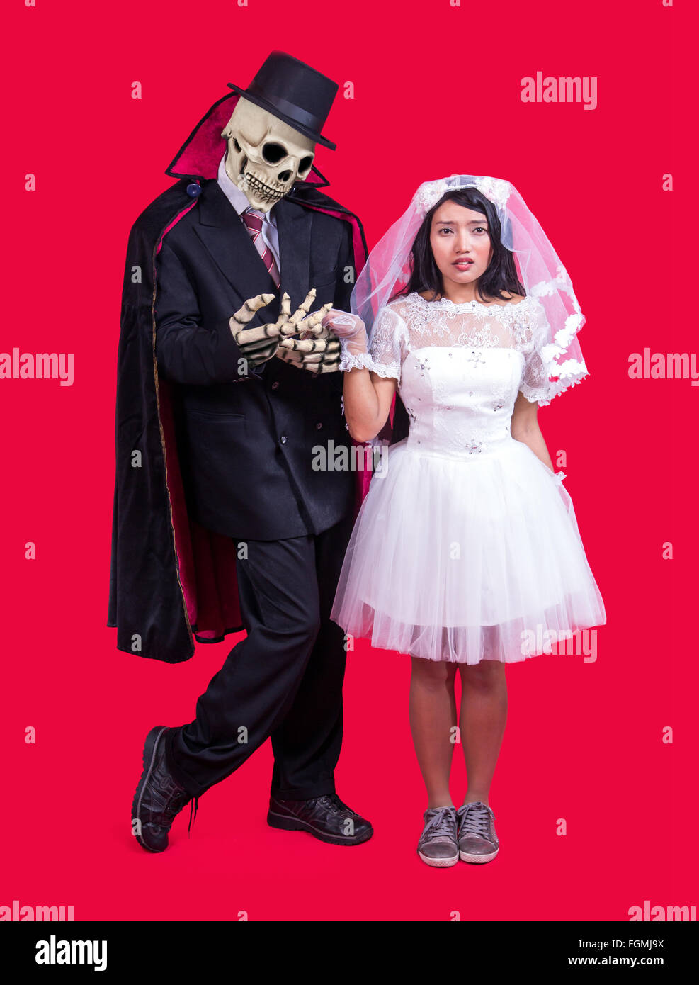 Skeleton as groom holds hand of bride Stock Photo - Alamy