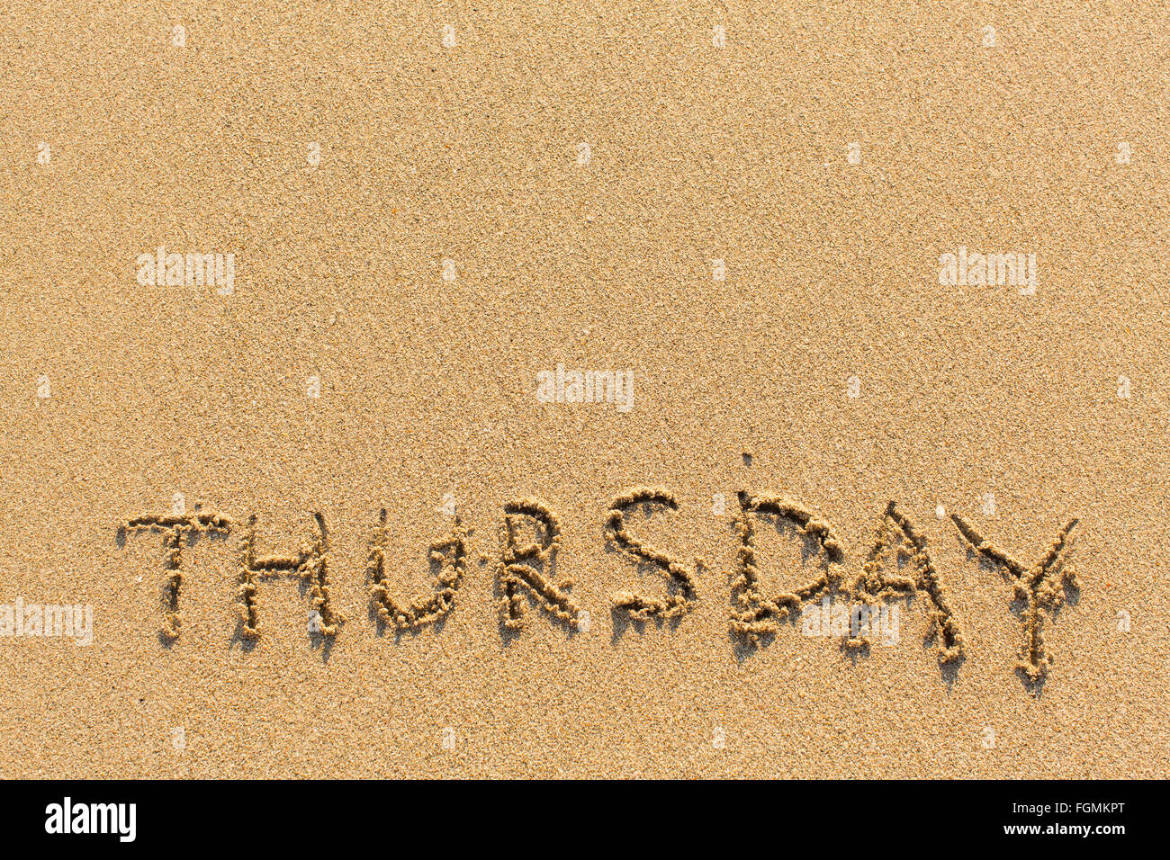 Thursday - word drawn on the sand beach Stock Photo - Alamy