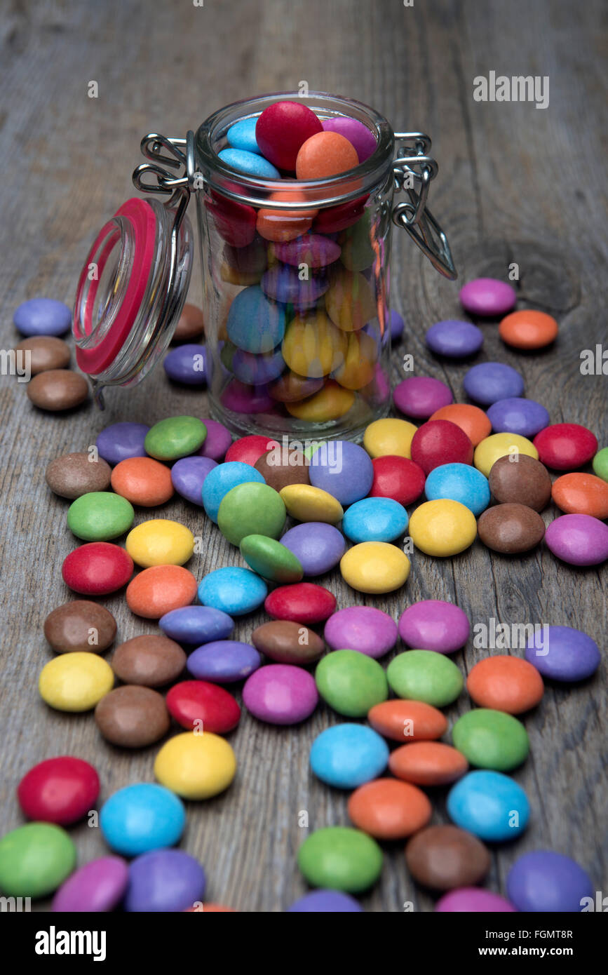A glass jar full of chocolate coated Smarties Stock Photo - Alamy