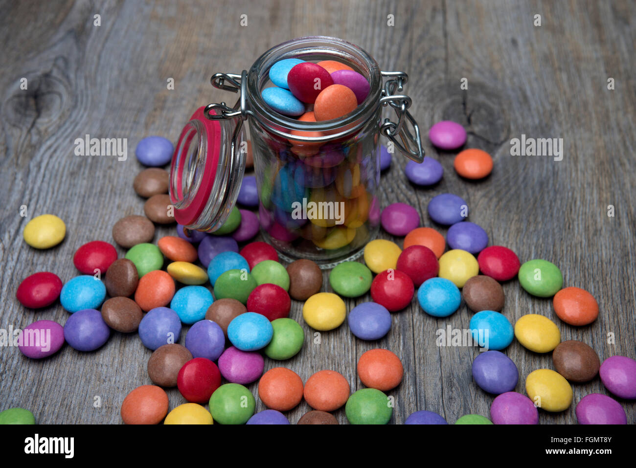 A glass jar full of chocolate coated Smarties Stock Photo - Alamy
