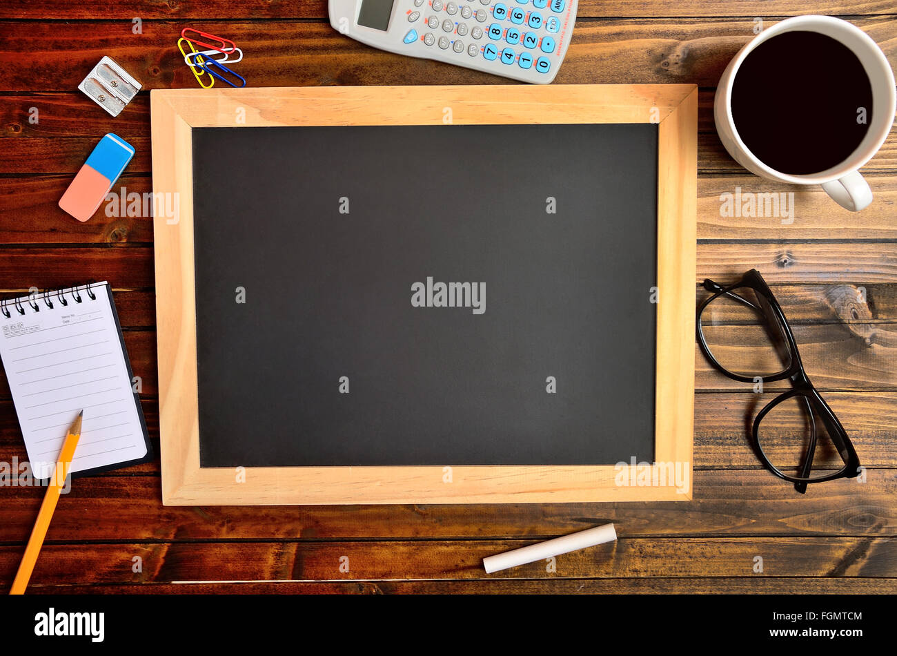Chalkboard with office utensil on wooden table Stock Photo - Alamy