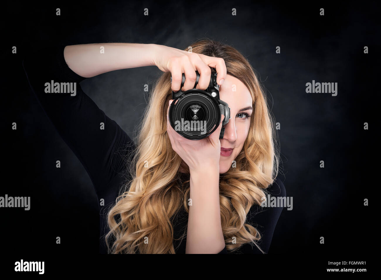 Photographer woman holding camera Stock Photo - Alamy