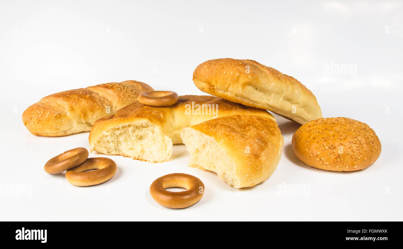 whole wheat two breads, unleavened wheat cake and bun on white ...