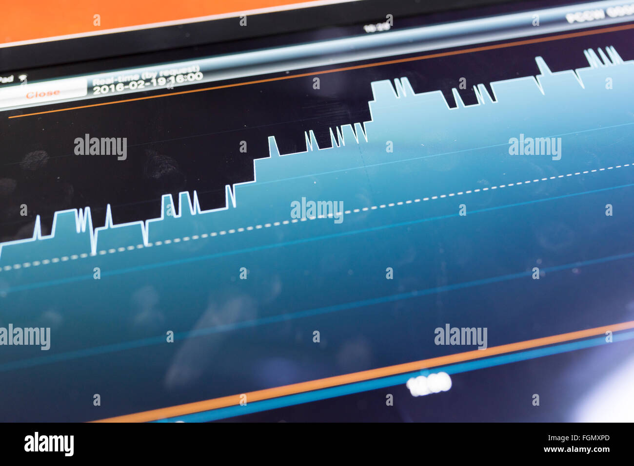 Tablet with stock graph on a wood table Stock Photo - Alamy