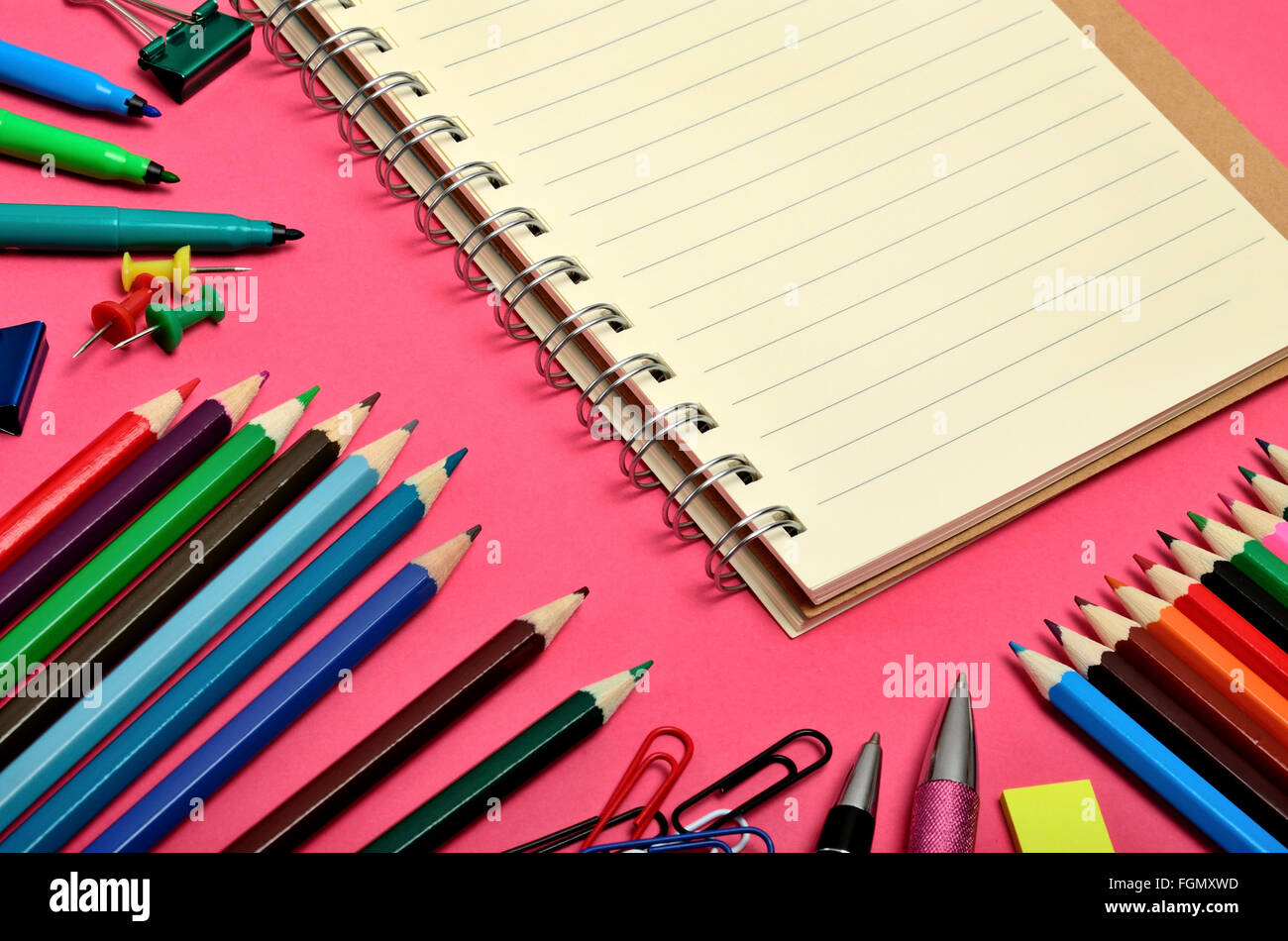 Notebook with school accessories on pink background Stock Photo - Alamy
