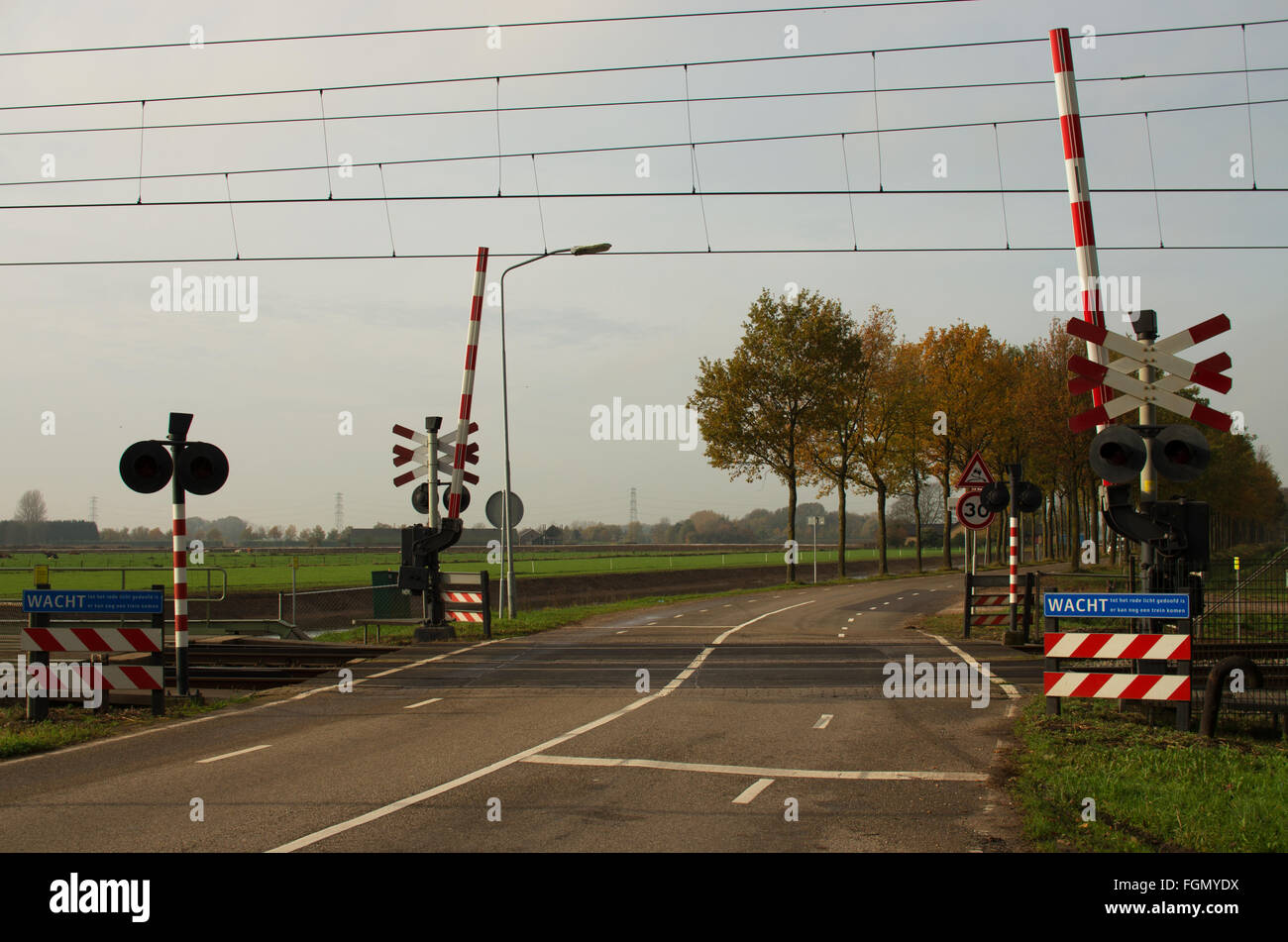 Level crossing with opened barriers Stock Photo - Alamy