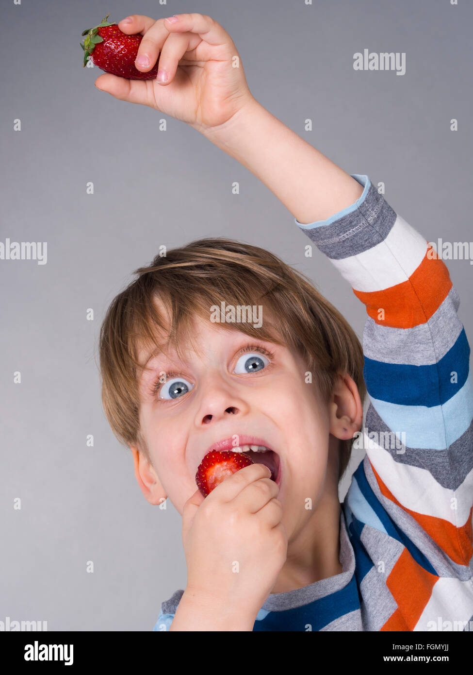 boy eating strawberries Stock Photo - Alamy
