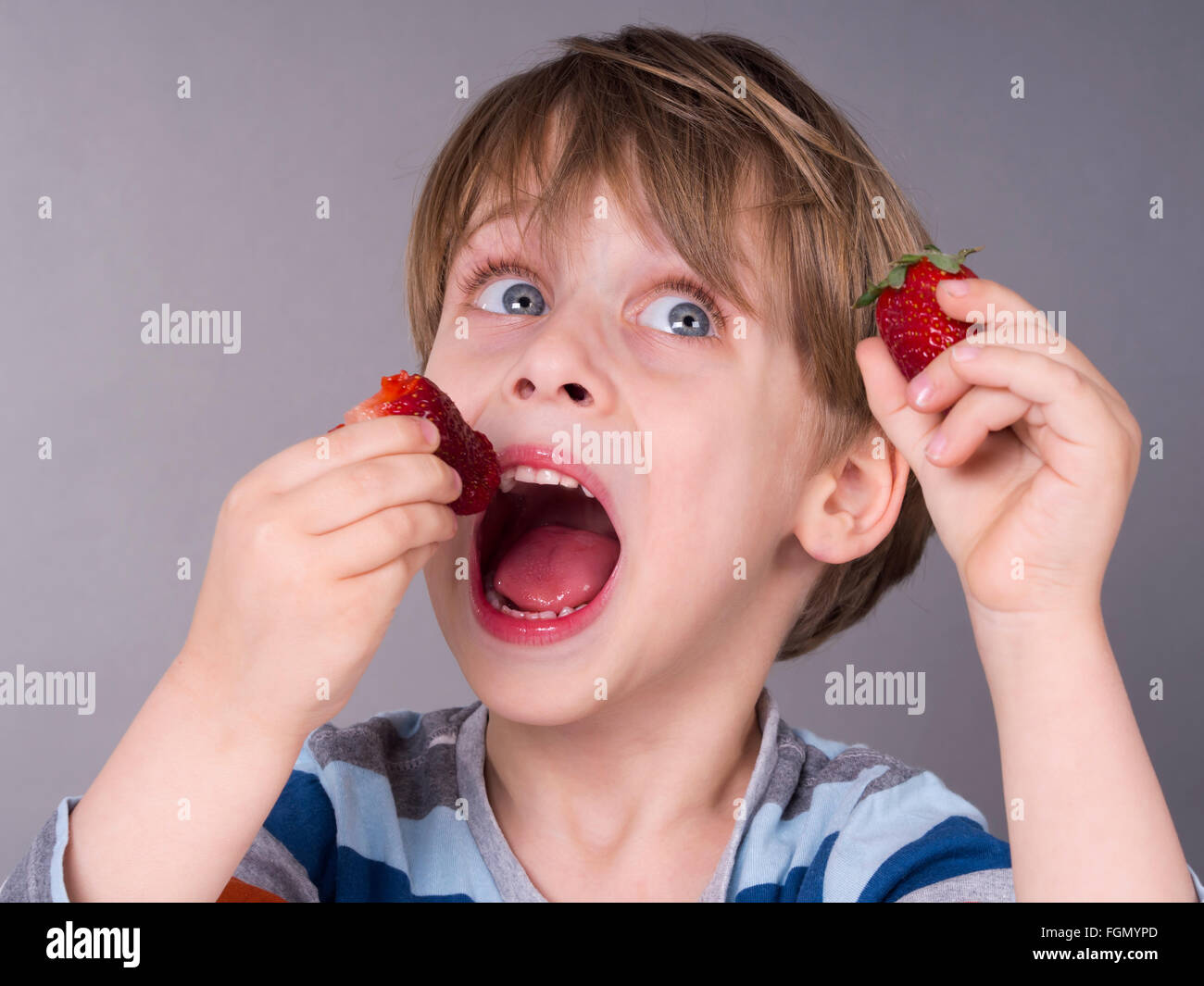 boy eating strawberries Stock Photo - Alamy