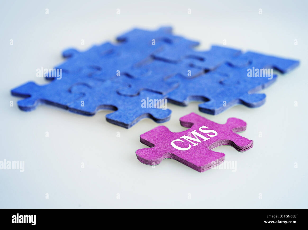 Puzzle word CMS on blue background Stock Photo - Alamy