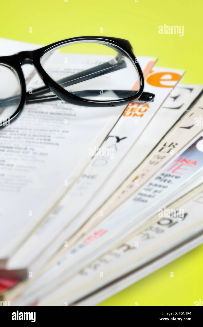 Stacked magazines on yellow background Stock Photo - Alamy