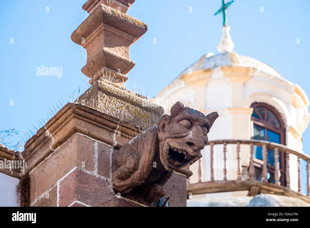 Gargoyle on stone pillar, in the well preserved old mountain town of ...