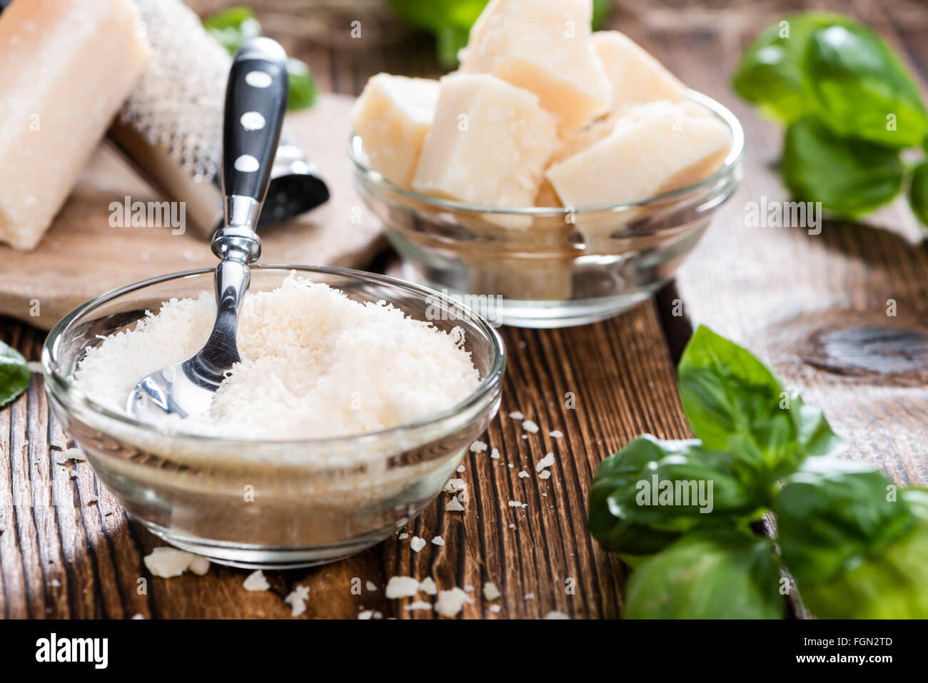 Heap of grated Parmesan (close-up shot) on wooden background Stock ...