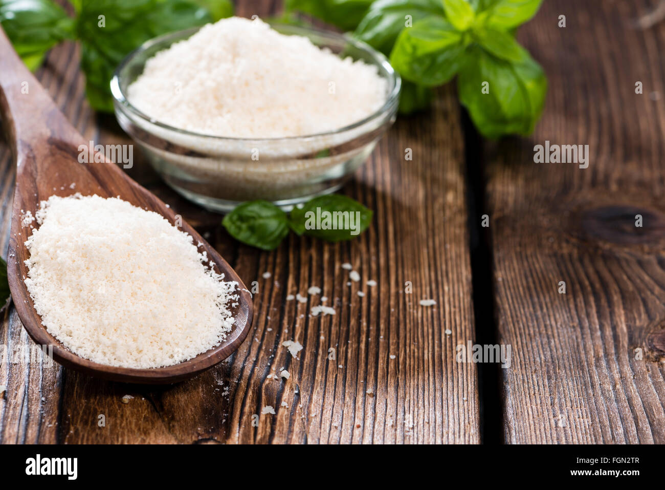 Heap of grated Parmesan (close-up shot) on wooden background Stock ...