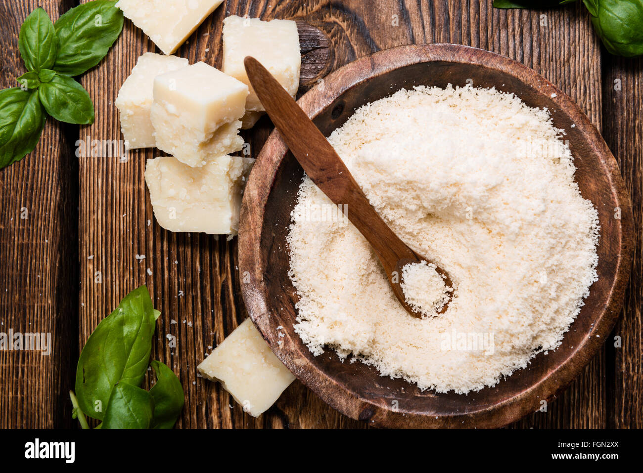 Grated Parmesan with Basil on dark vintage background Stock Photo - Alamy