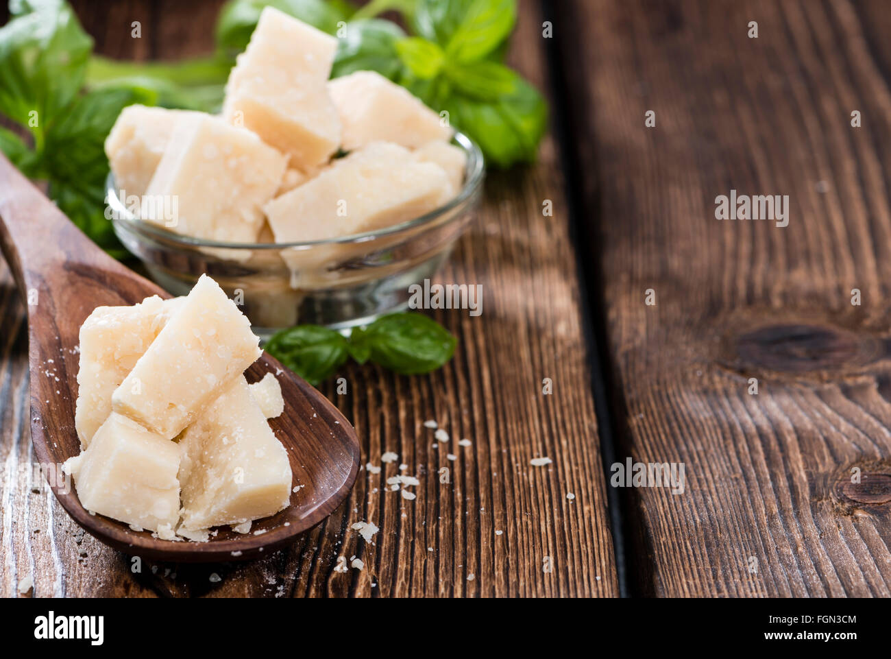 Parmesan Cheese with Basil (close-up shot) on dark woden background ...