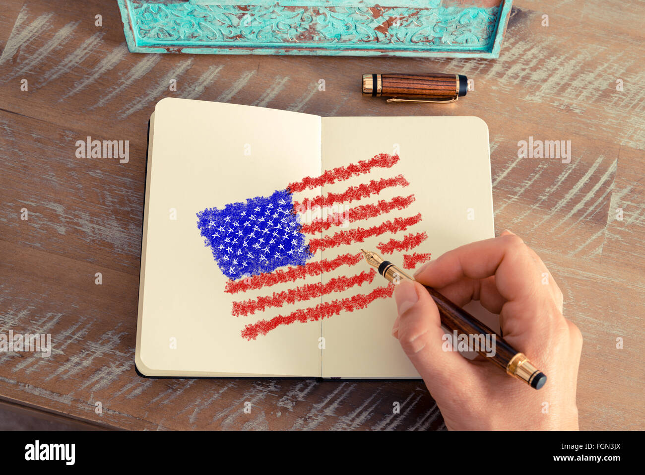 Retro effect and toned image of a woman hand drawing the American Flag ...