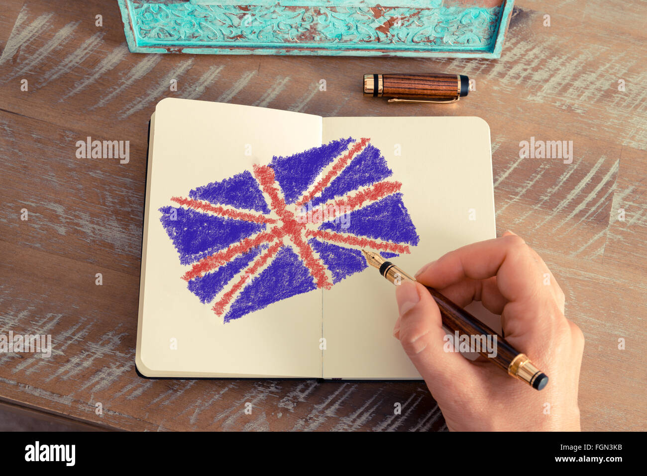 Retro effect and toned image of a woman hand drawing the Union Jack ...