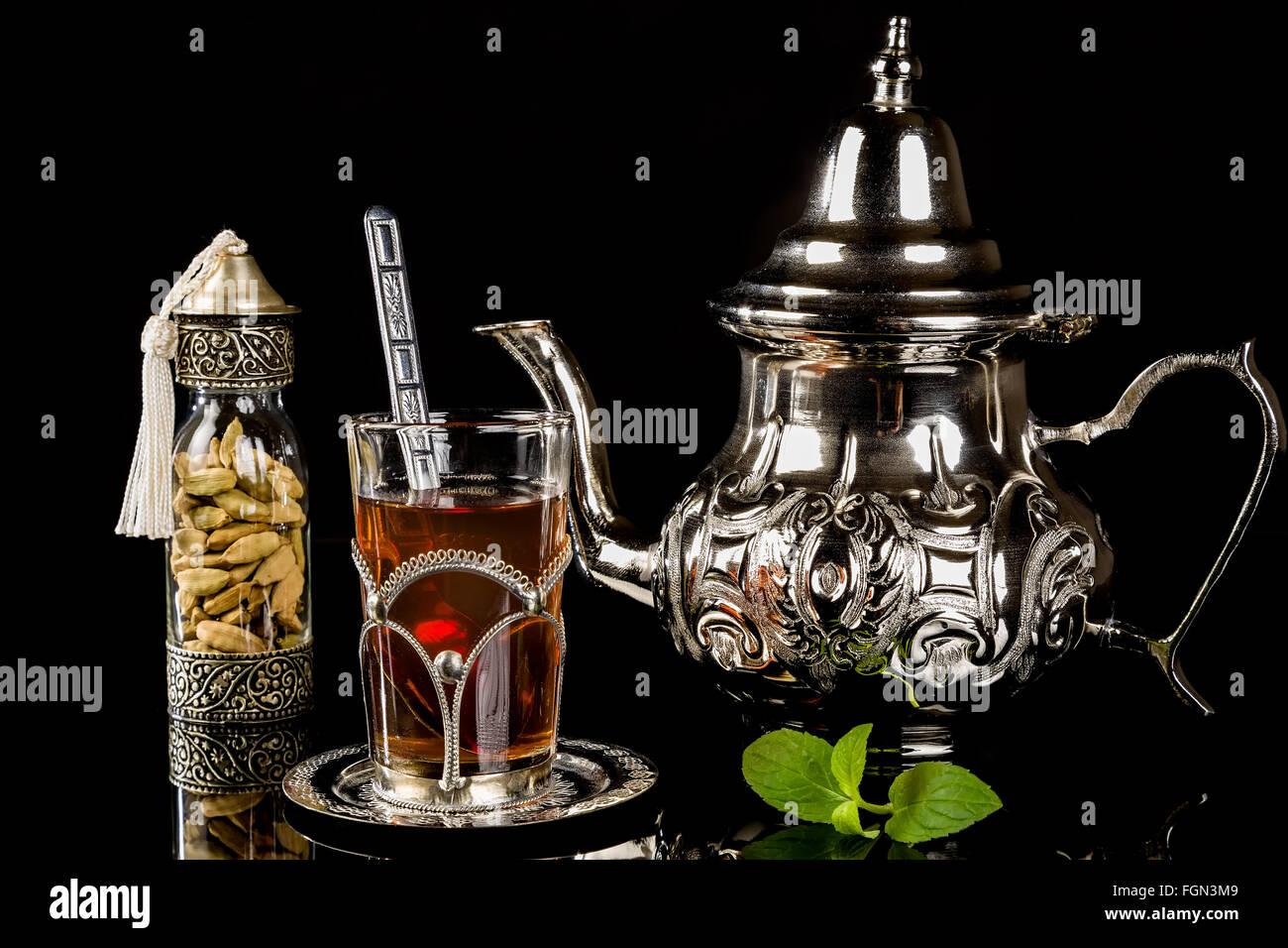Arabic mint tea and cardamon seeds on the black background Stock Photo ...