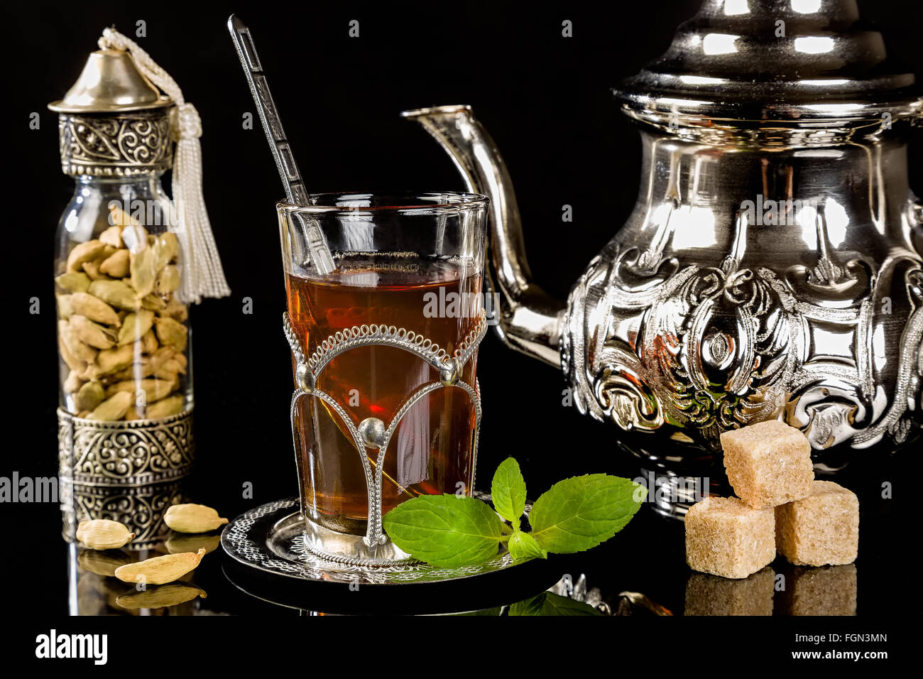 Arabic mint tea and cardamon seeds on the black background Stock Photo ...