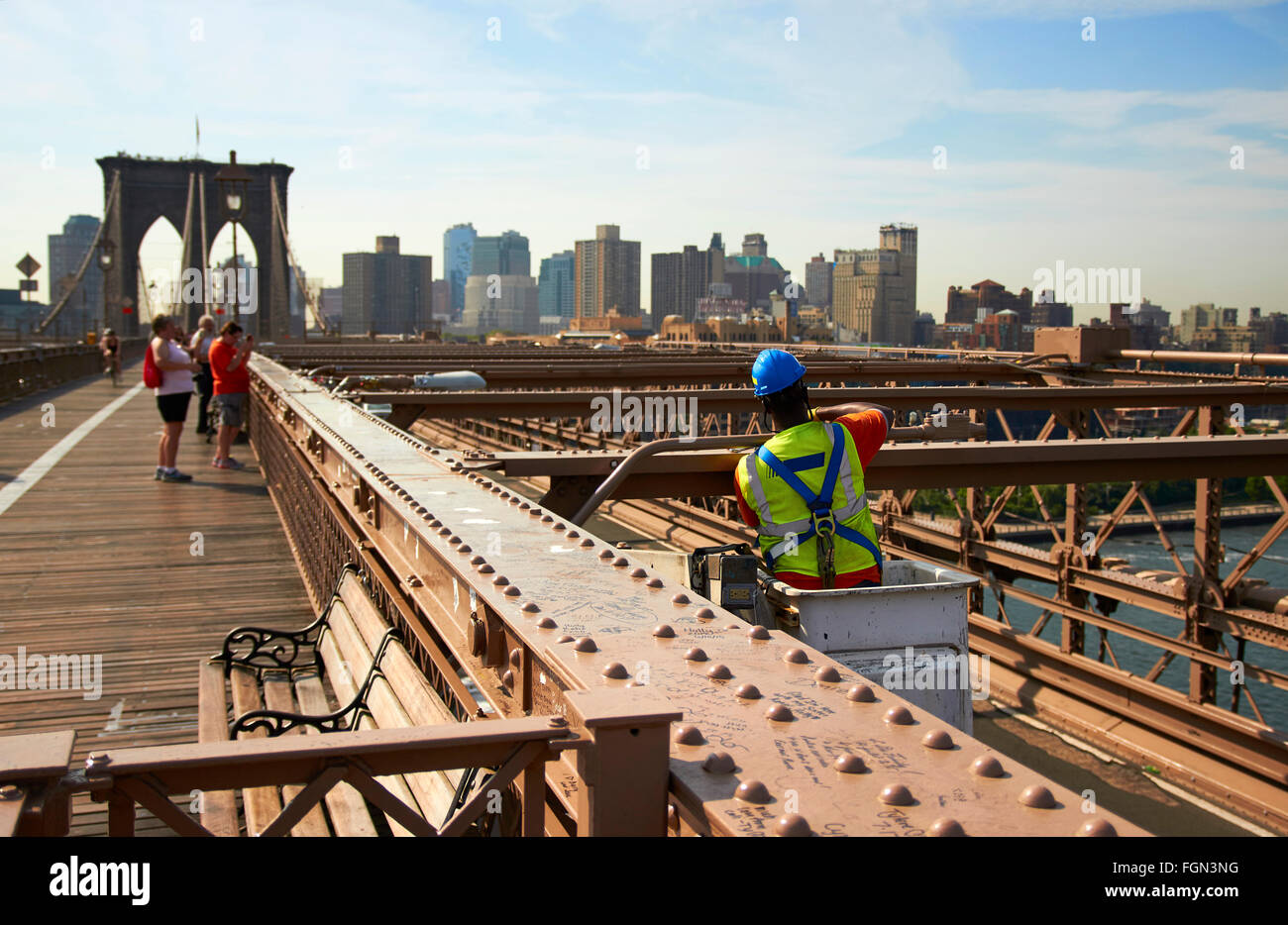 A construction worker on Brooklyn Bridge at busy sunny day Stock Photo ...
