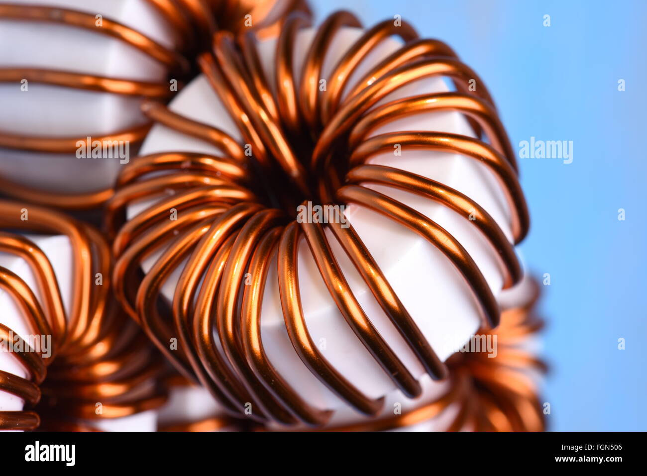 Macro of a copper coils on blue background Stock Photo - Alamy