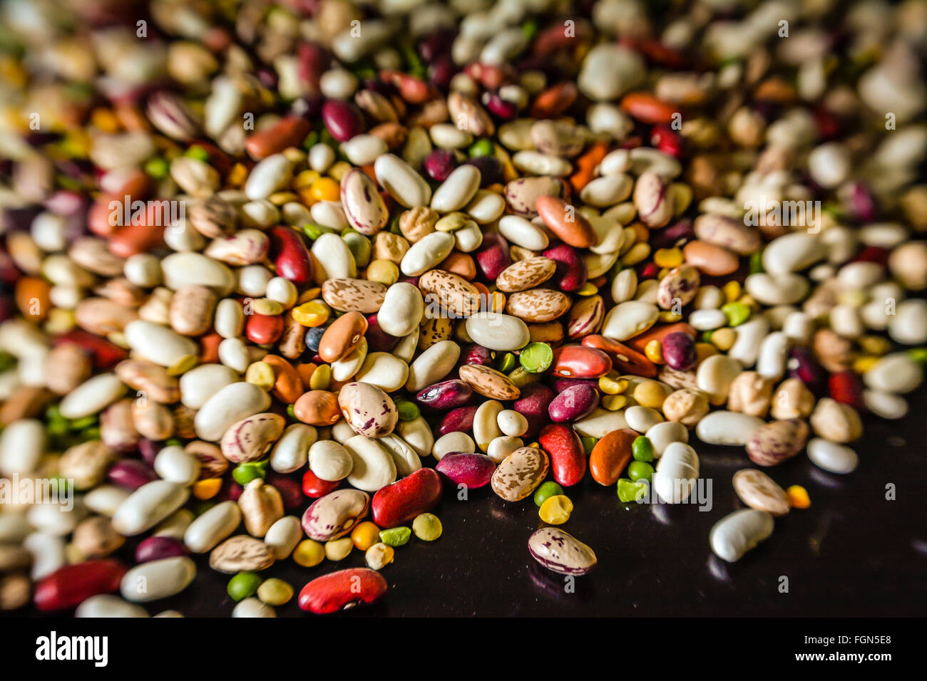 A huge pile of mixed dried beans of all varieties make a colorful ...