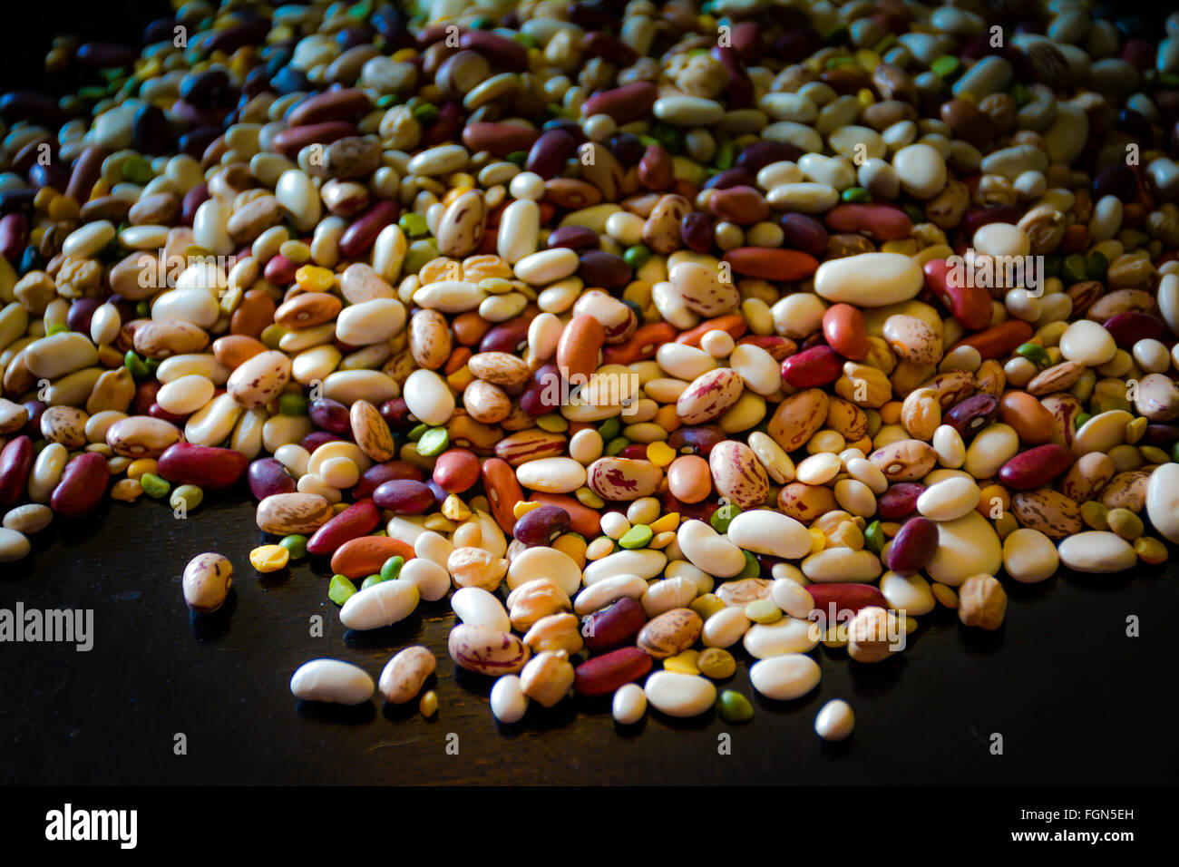 A huge pile of mixed dried beans of all varieties make a colorful ...