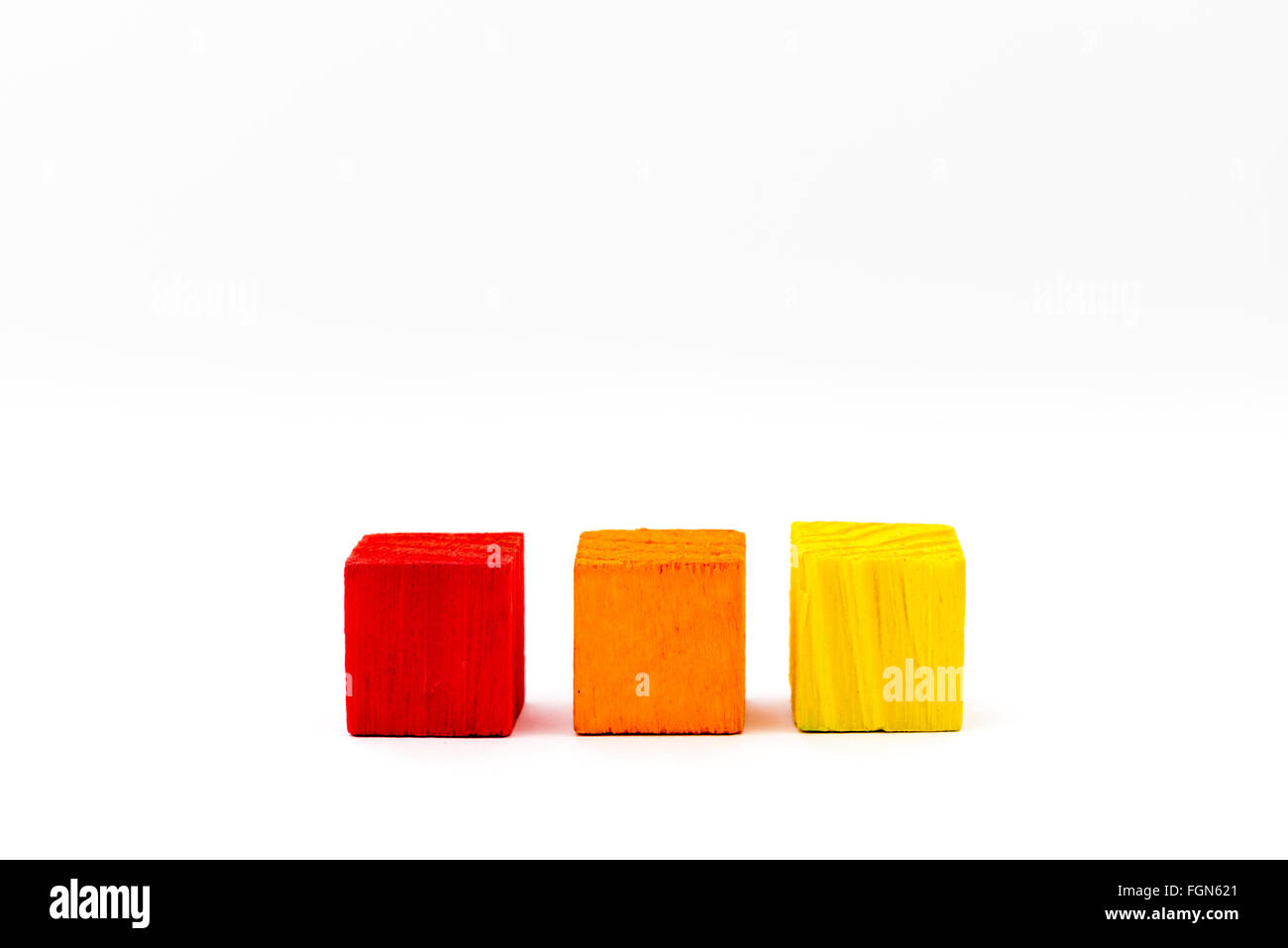 Three toy wooden colored blocks isolated on white background, copy ...