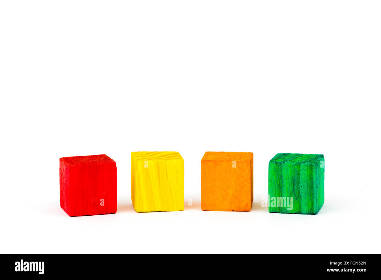 Four toy wooden colored blocks isolated on white background, copy space ...