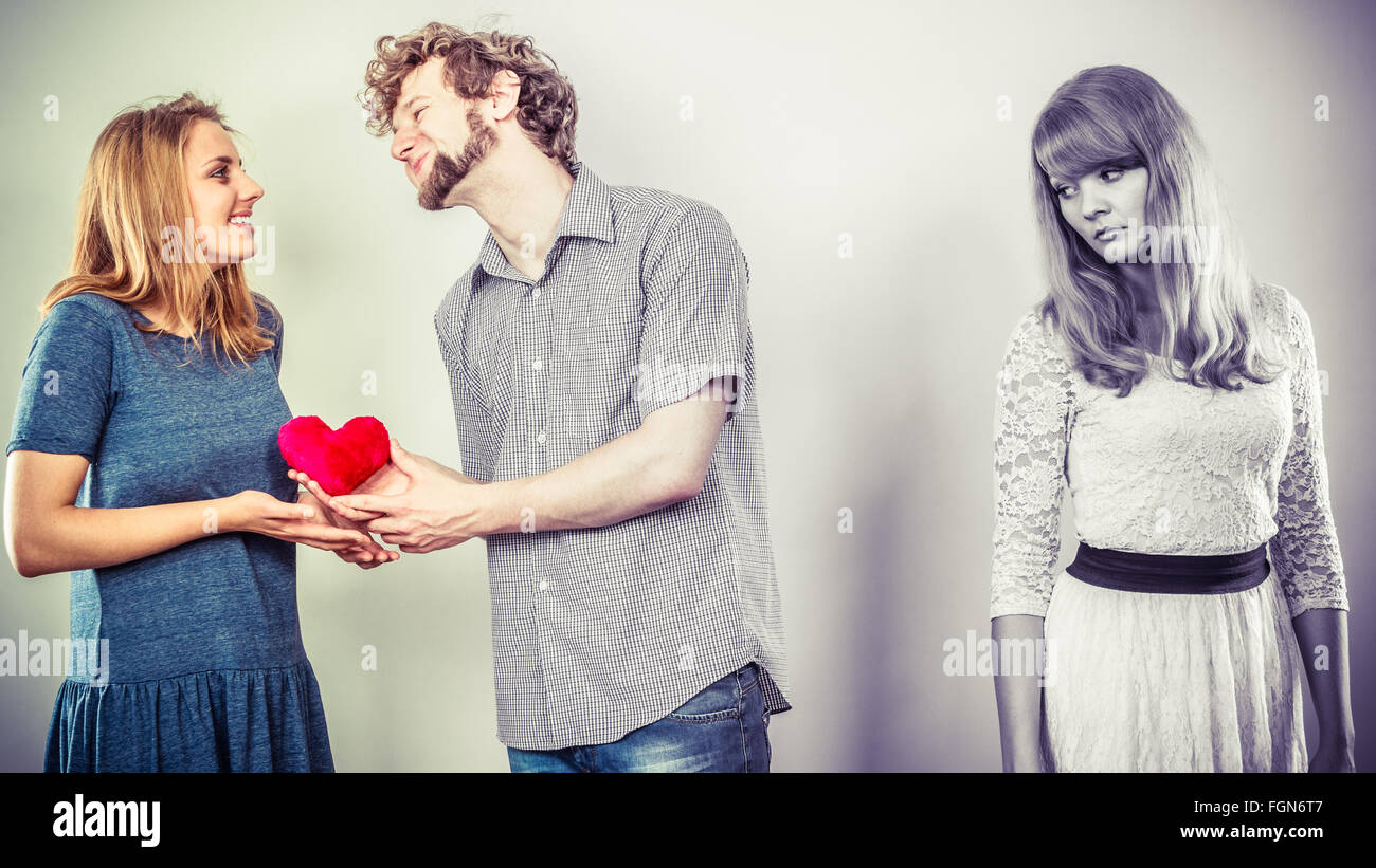 Jealousy and betrayal concept. Abandoned unloved girl watching on happy ...