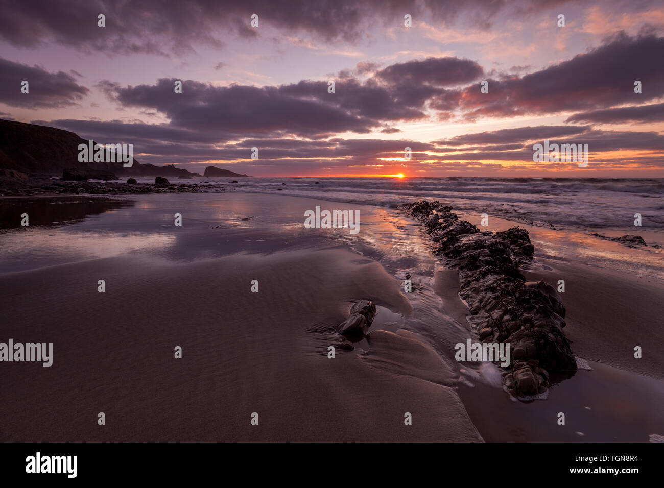 Sunset at Welcombe Mouth Beach in North Devon, UK. There is a beautiful ...