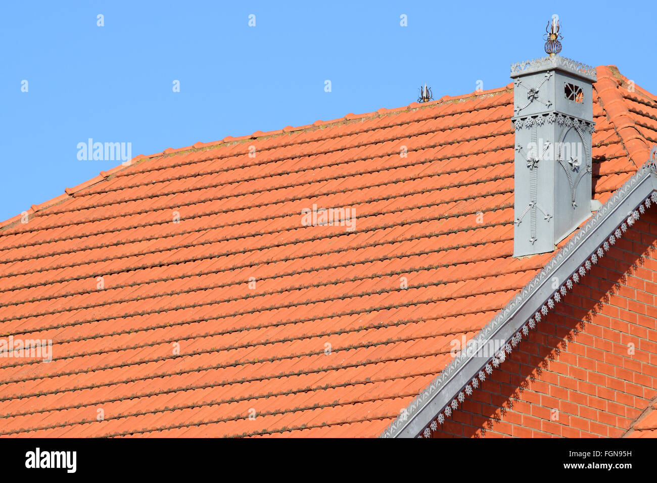 The house with a roof of tiles. The house with gables, windows and ...