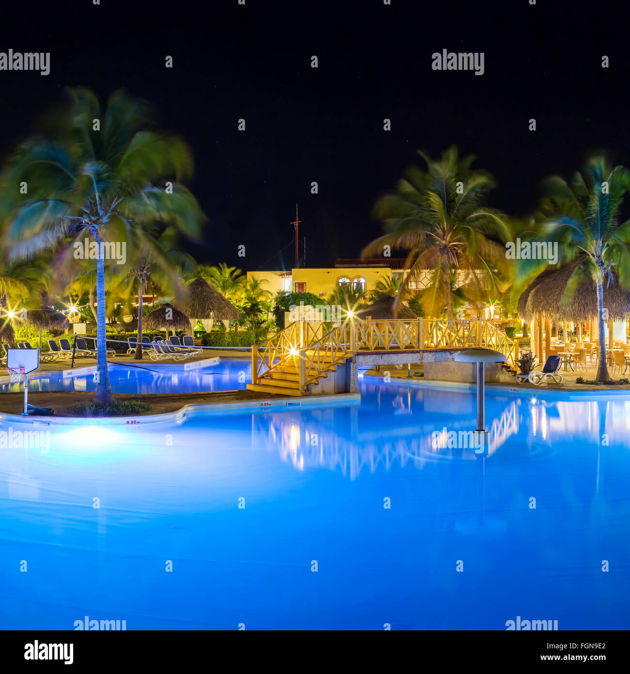 View of hotel and swimming pool at night Stock Photo - Alamy