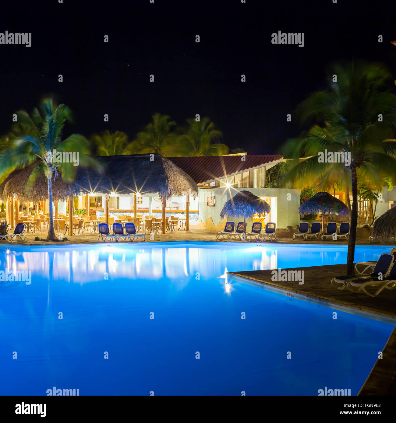 View of hotel and swimming pool at night Stock Photo - Alamy