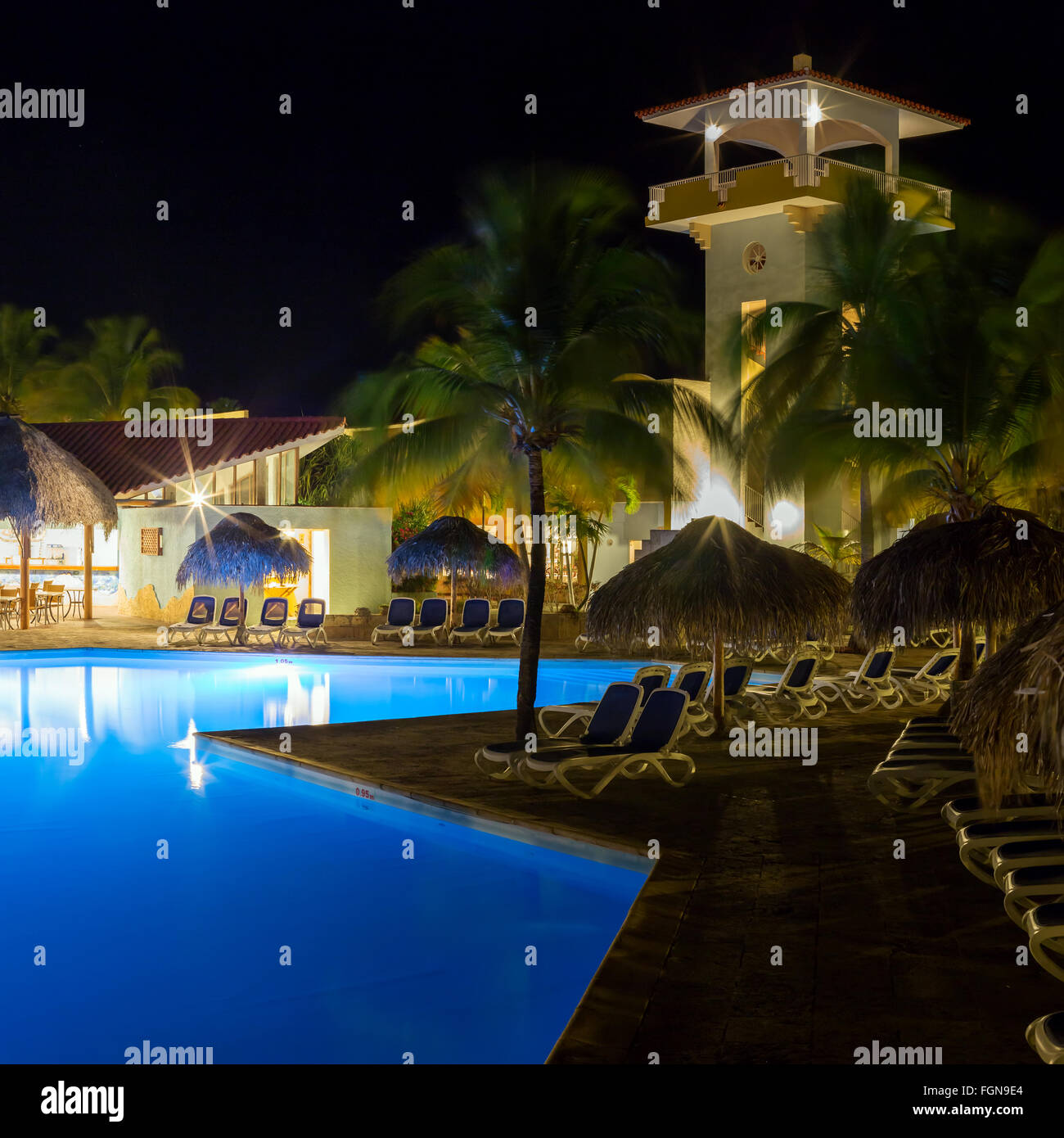 View of hotel and swimming pool at night Stock Photo - Alamy