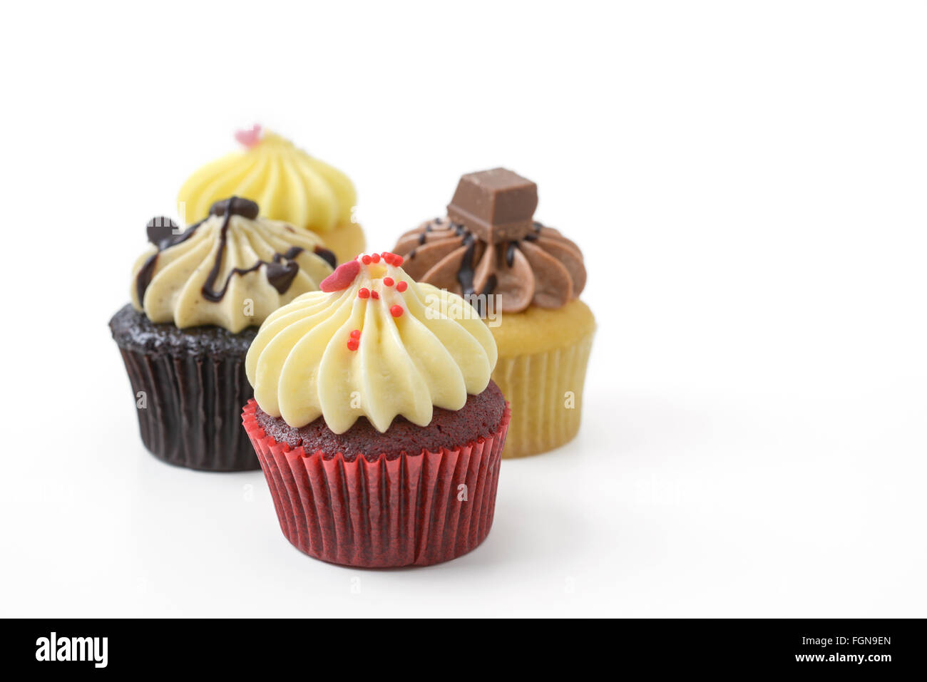 row of four cupcake on white background Stock Photo - Alamy