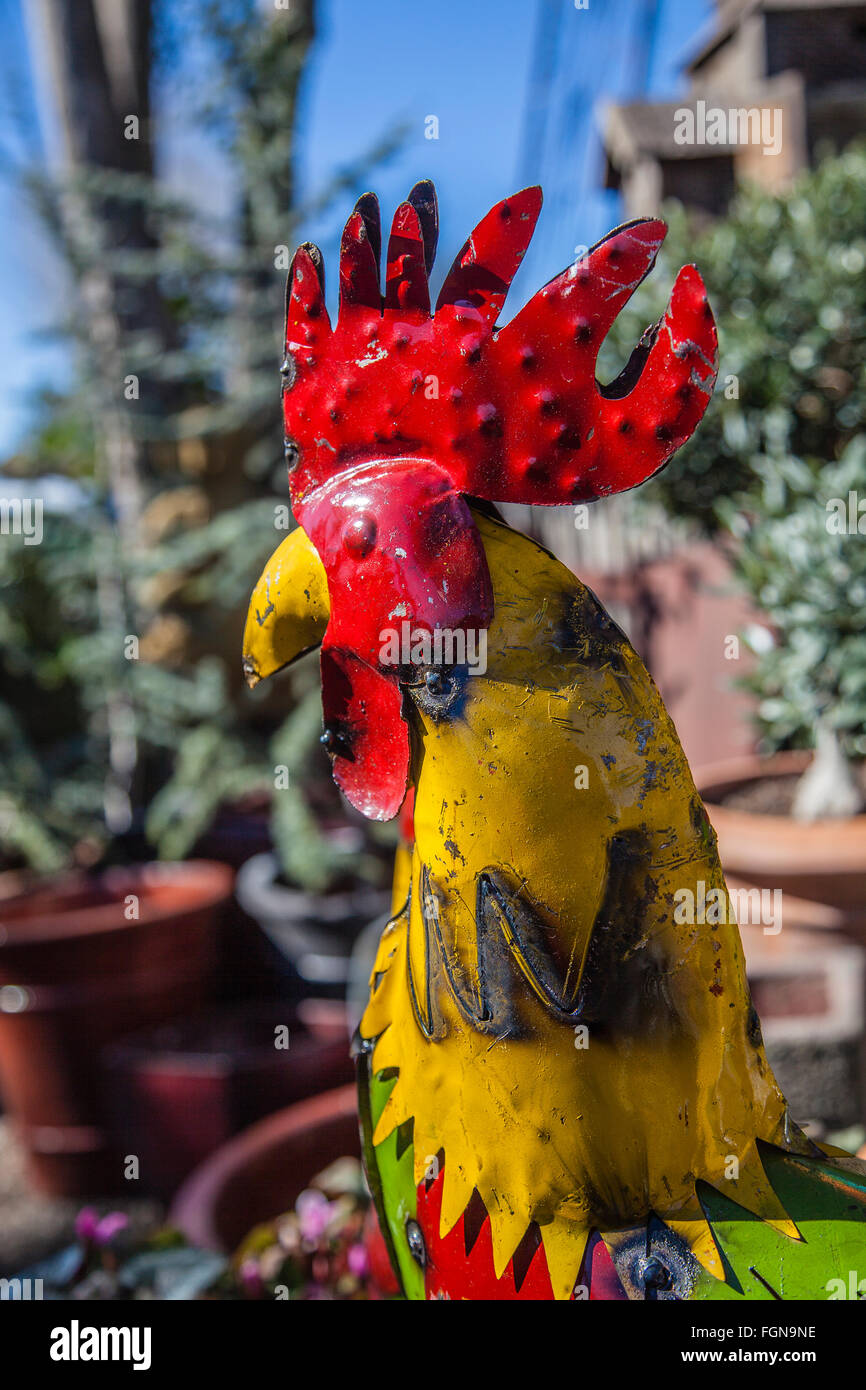 A metal hand-crafted rooster, painted red on the cock's comb and face ...