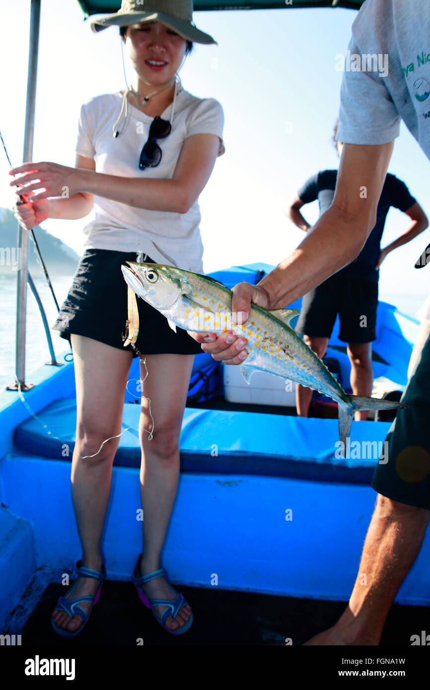 An Asian female tourist with a fresh catch of Spanish mackerel Stock ...