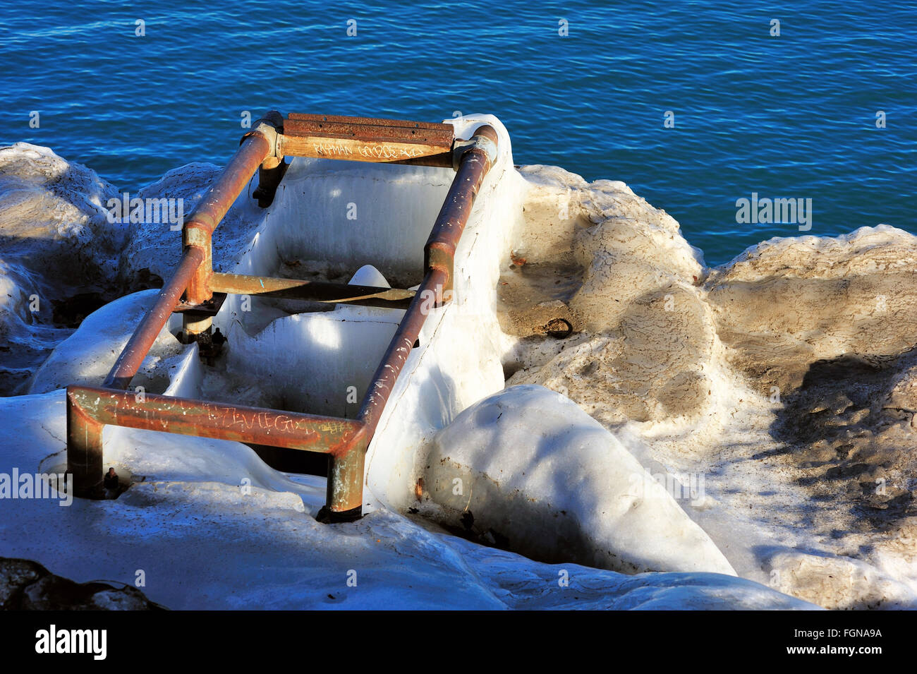 Ice coated pipes and rocks along the shore of Lake Michigan on Chicago ...