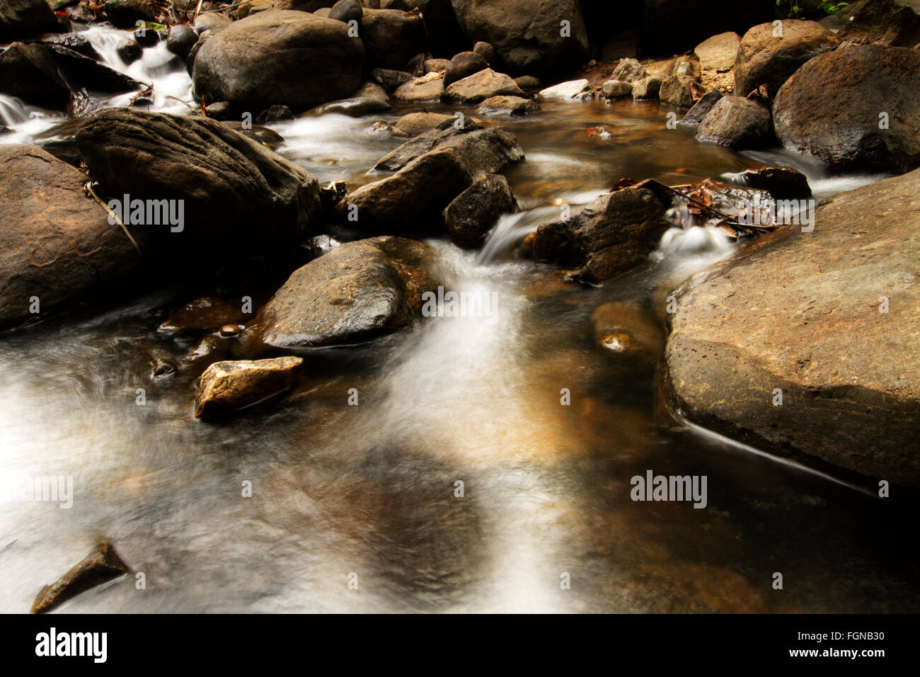 brown natural wet rocks in river water background Stock Photo - Alamy