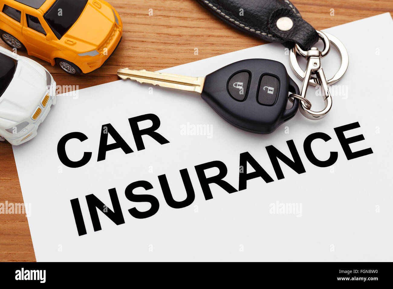Car insurance concept with car key on wood table Stock Photo - Alamy